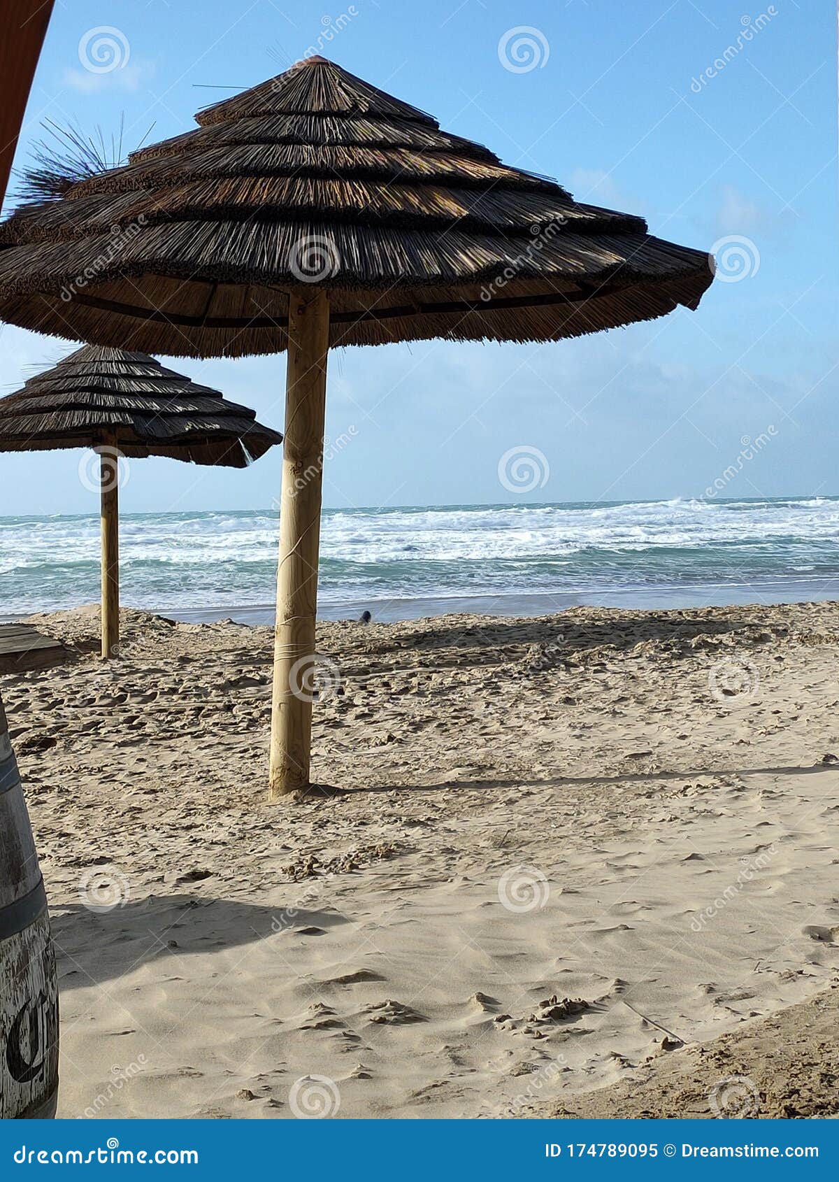 Tropical Beach with Woven Umbrellas Stock Image - Image of tropical ...
