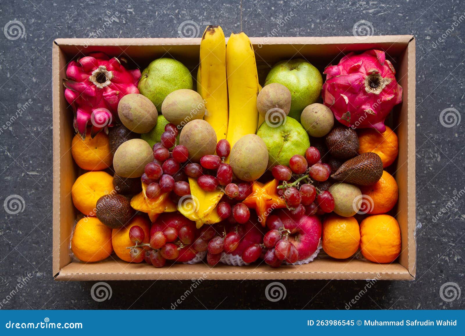 Tropical fruit in a box stock image. Image of banana - 263986545