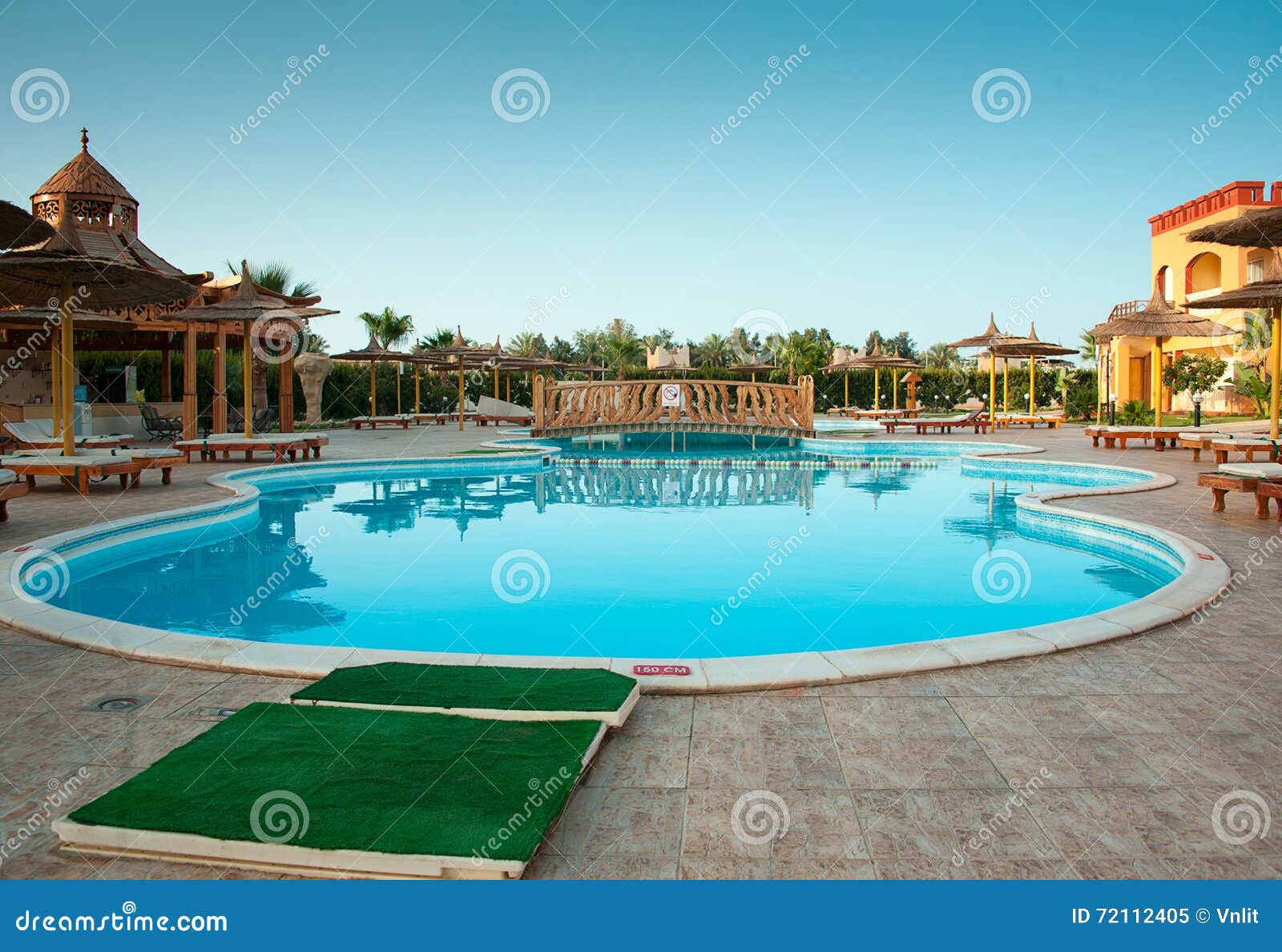 Tropical resort hotel pool stock image. Image of chair - 72112405