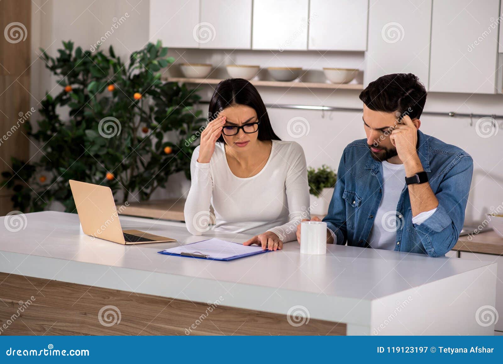 Troubled Couple Sitting in the Kitchen Stock Image - Image of computer ...