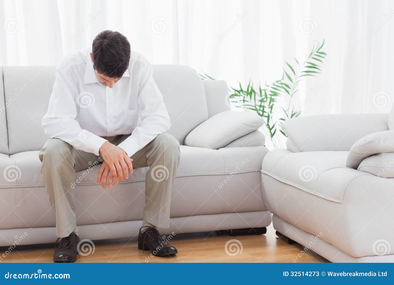 Troubled Young Man Sitting on Sofa Stock Image - Image of home, lounge ...