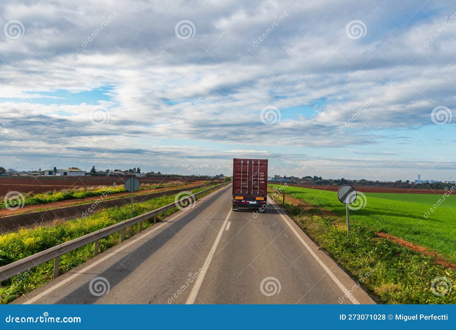 Truck with a Container Circulating on a Conventional Road Next To ...