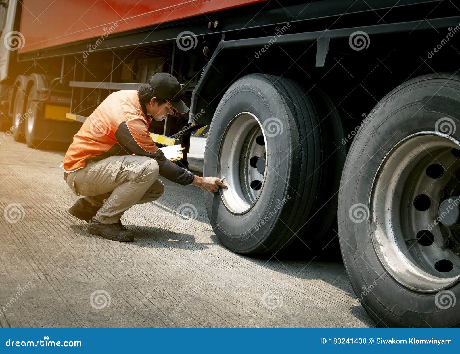 Truck Driver Inspecting Safety daily Check a Truck Wheels Stock Photo ...