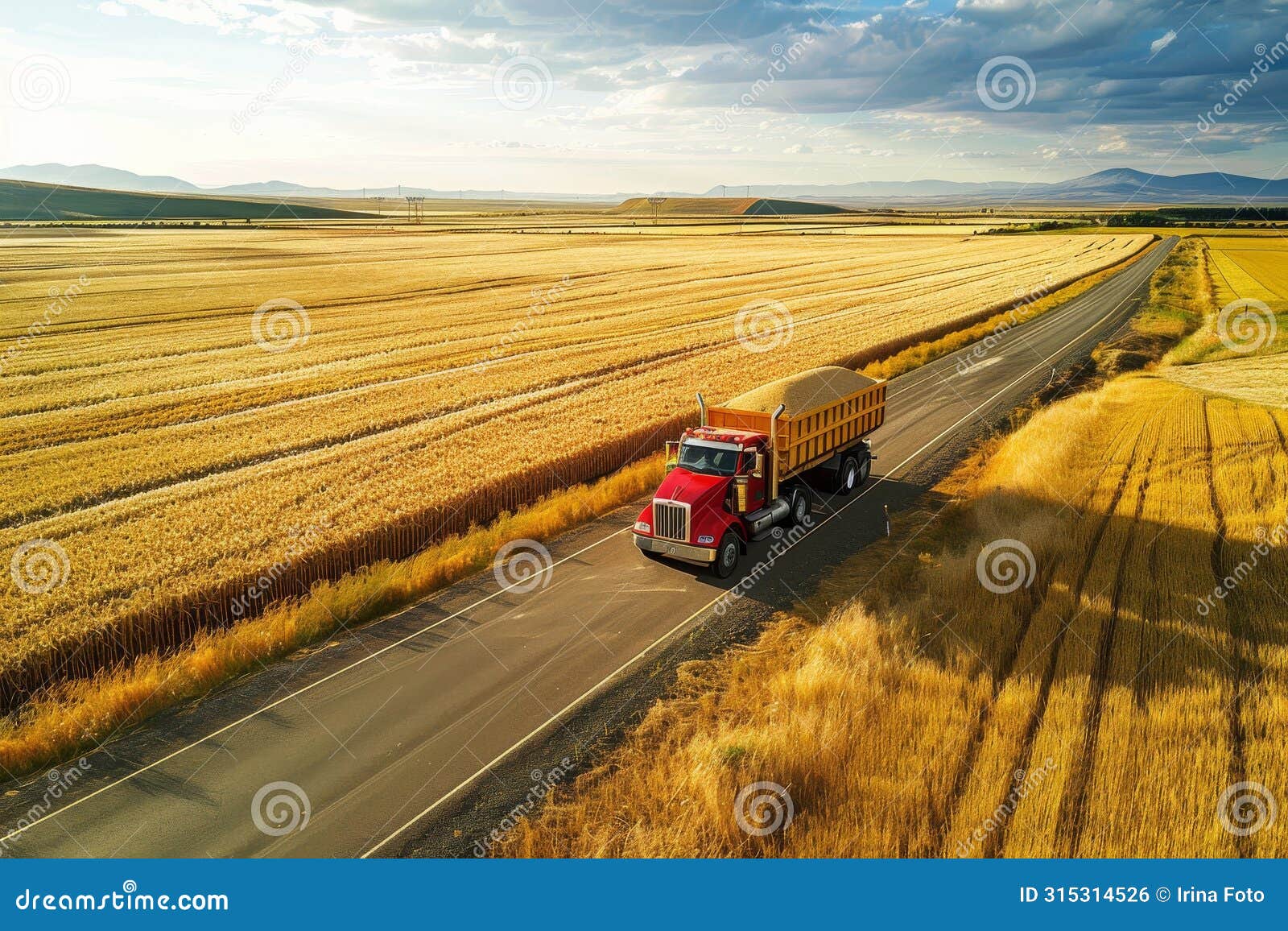 Truck Driving on Road with Wheat Fields and Clouds Backdrop Stock Photo ...