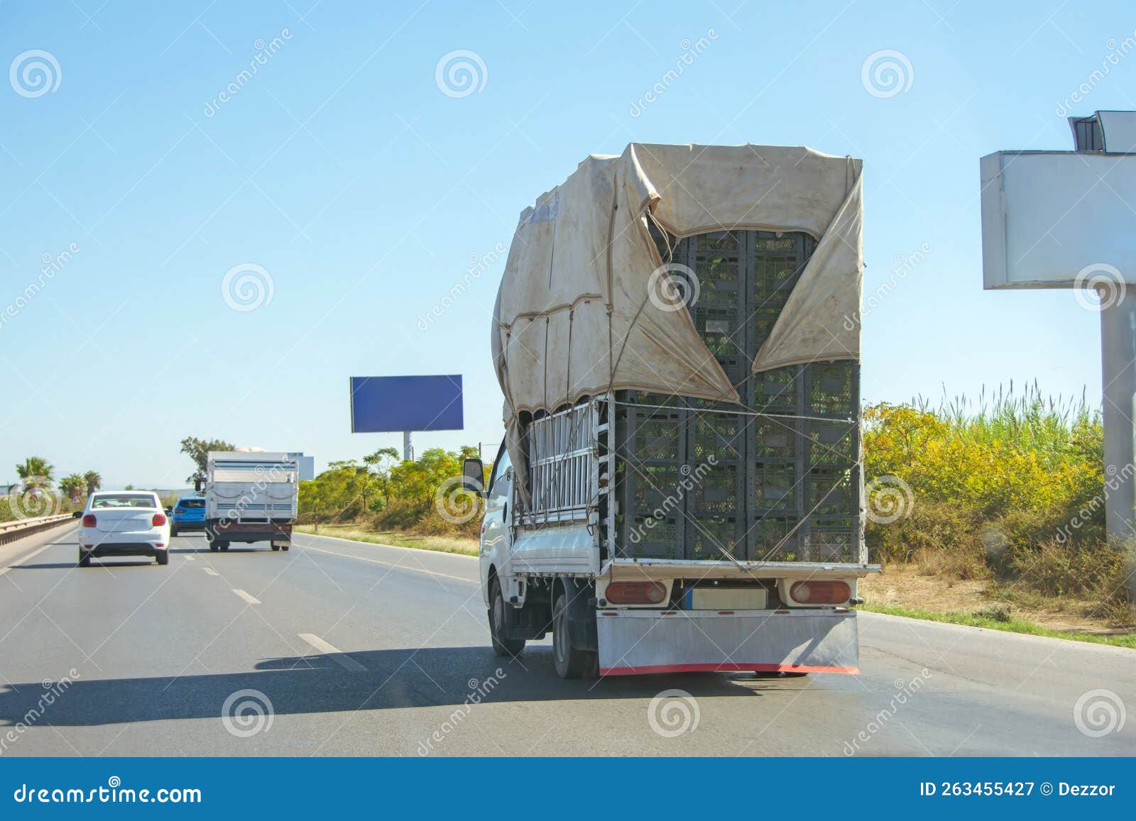 Truck Full of Vegetables in a High Stack of Boxes is Loaded and Driving ...