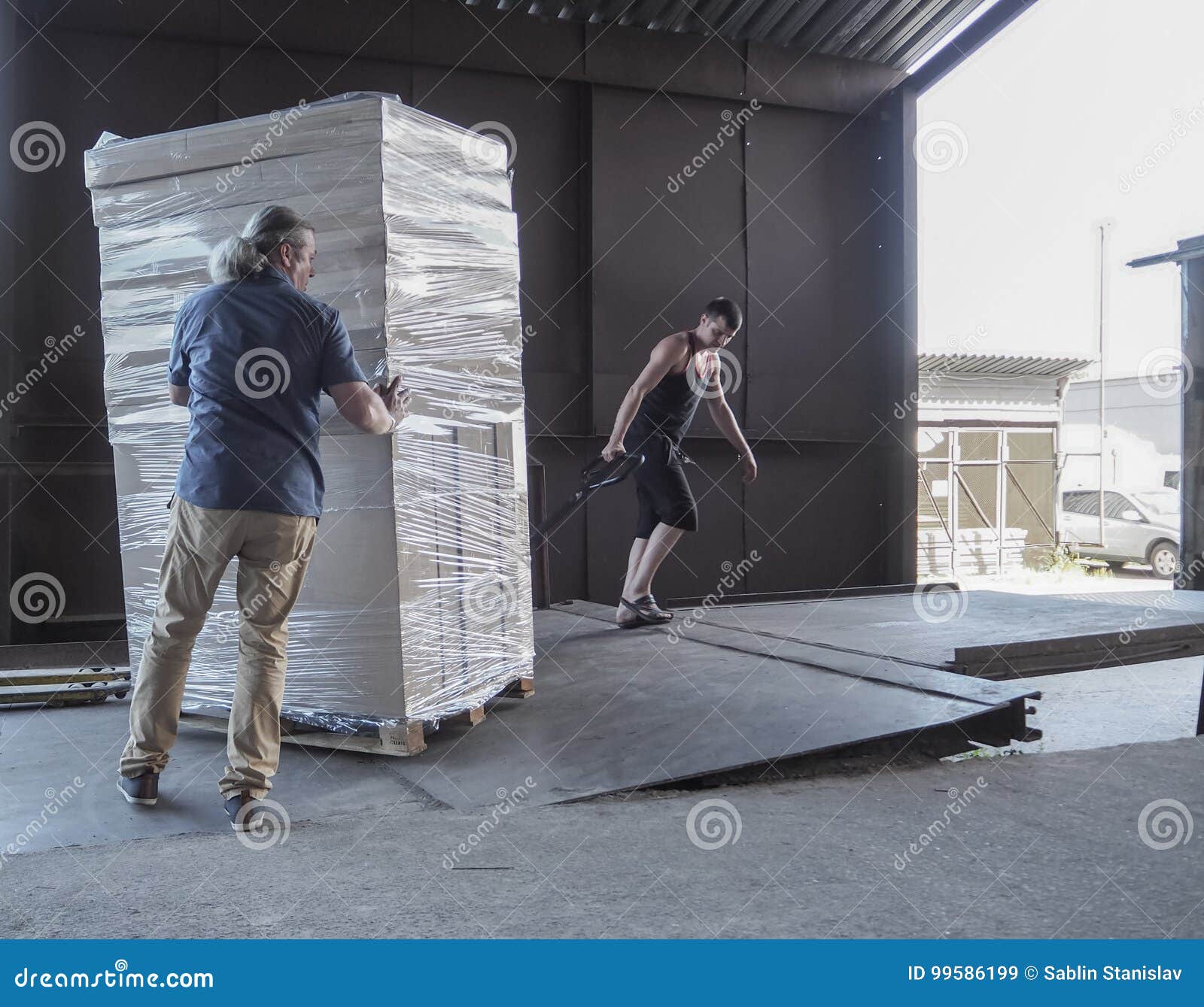 Truck Loading and Shipping. Male Workers are Loading the Goods in ...