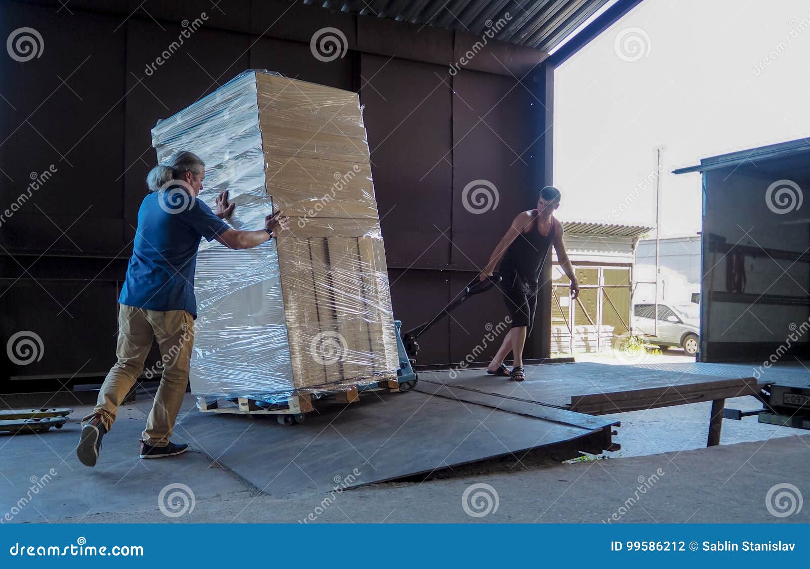 Truck Loading and Shipping. Male Workers are Loading the Goods in ...