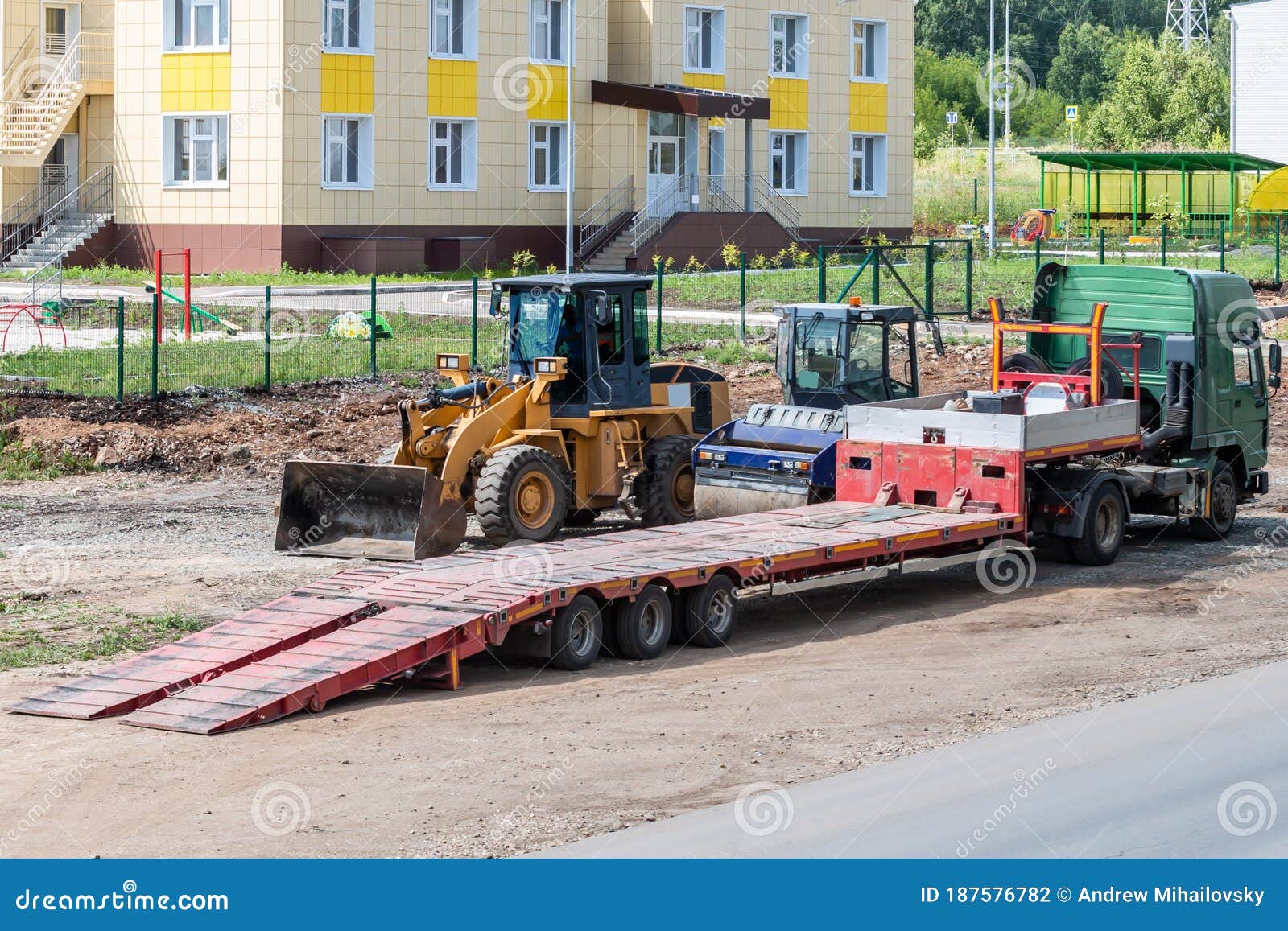 Truck with Low Loader, Road Roller and Wheeled Tractor on Road Repair ...