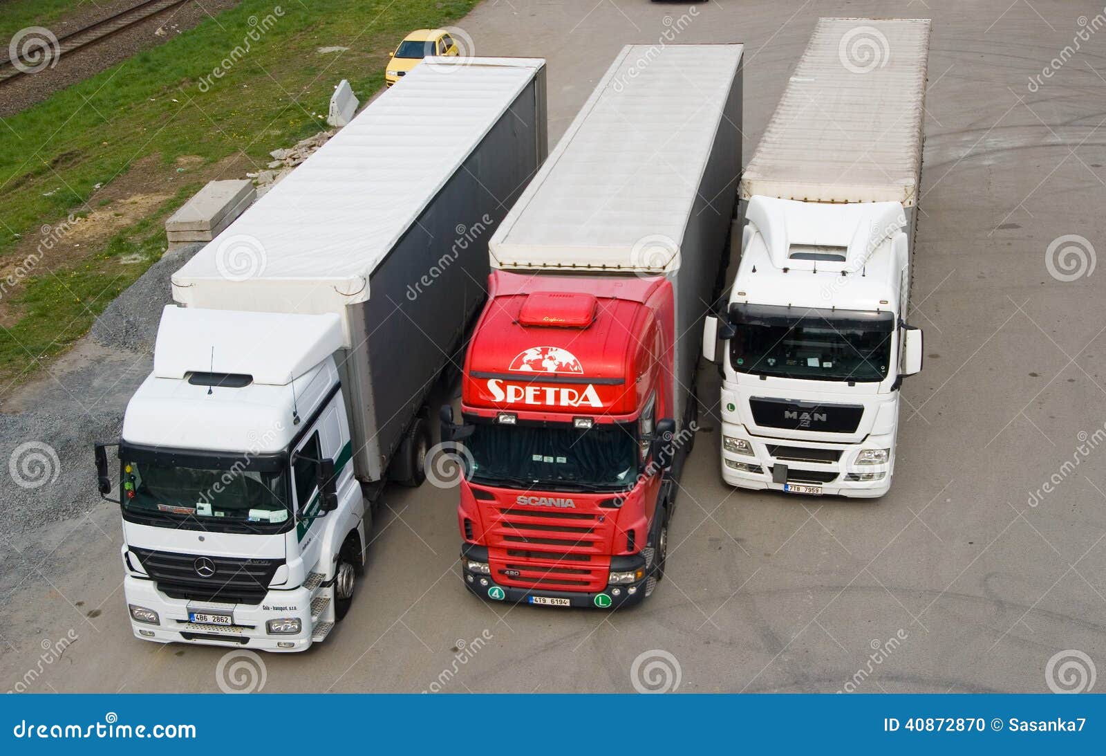 Three Trucks Passing By In A Highway With Rock Hill In Background ...