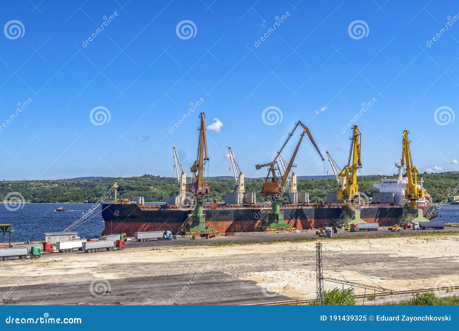 Trucks with Grain Waiting for Unloading Near the Ship. Editorial Image ...