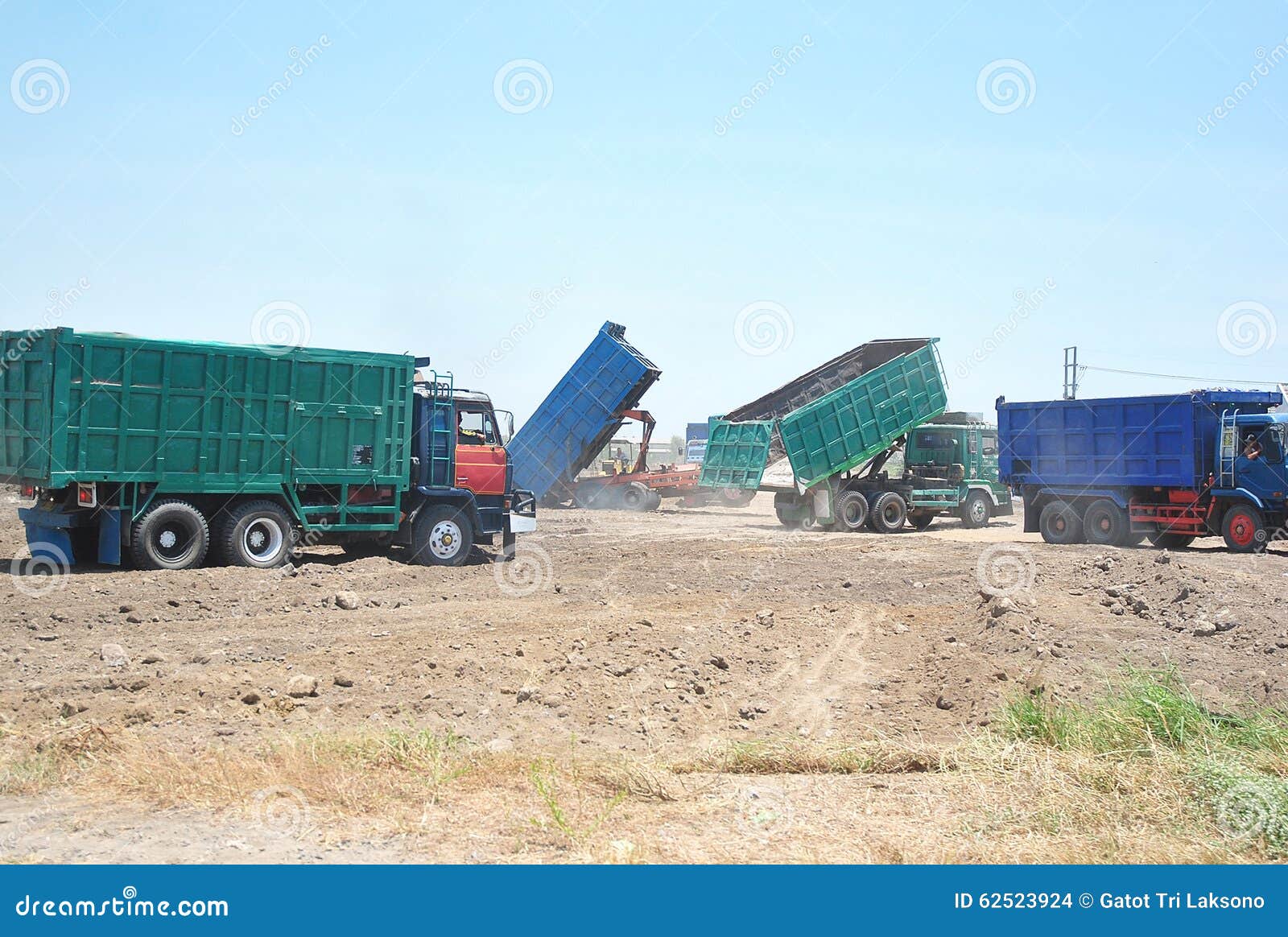 Trucks releasing the sand stock photo. Image of dumping - 62523924