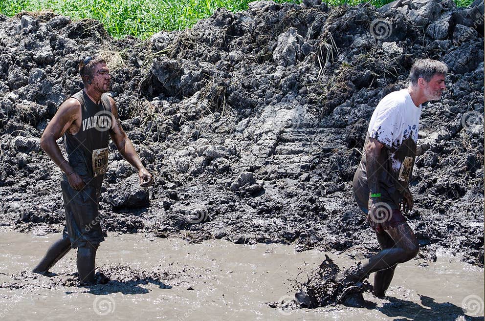 Trudging through mud editorial image. Image of people - 25882470