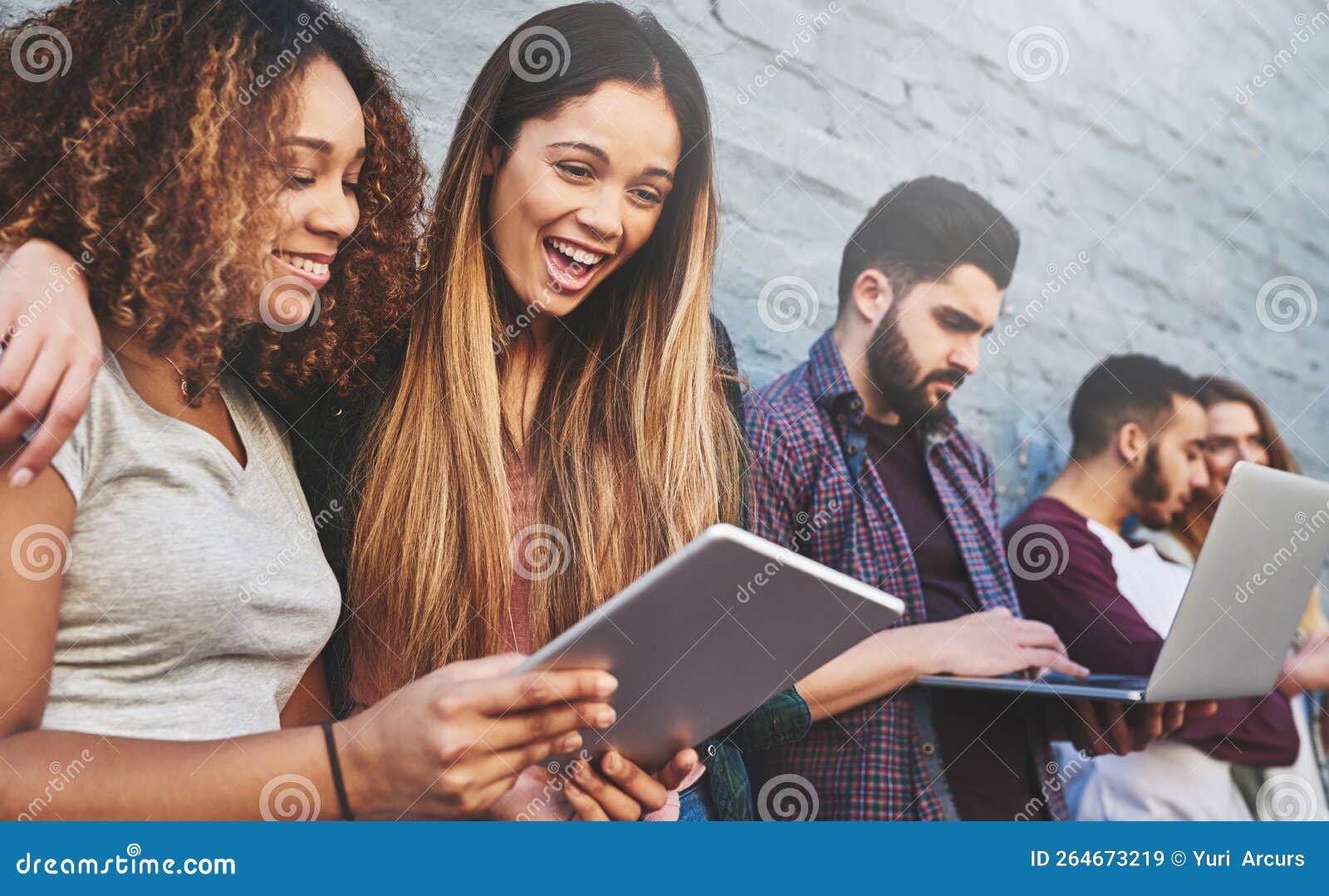 True Friends Share Everything. a Group of Young Friends Using Their ...