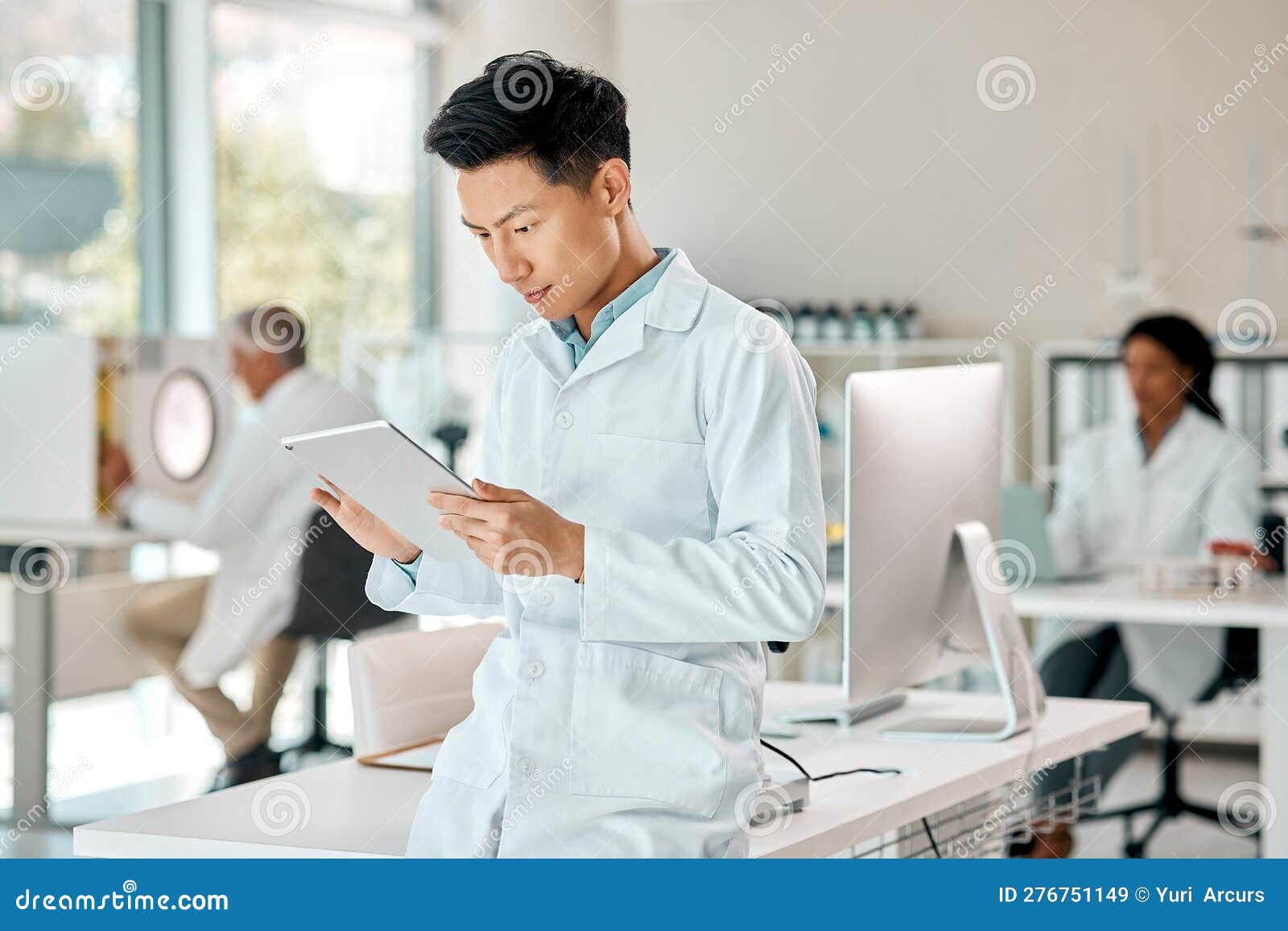 A True Genius at Work. a Young Scientist Using a Digital Tablet in a ... A True Genius at Work. a Young Scientist Using a Digital Tablet in a ...