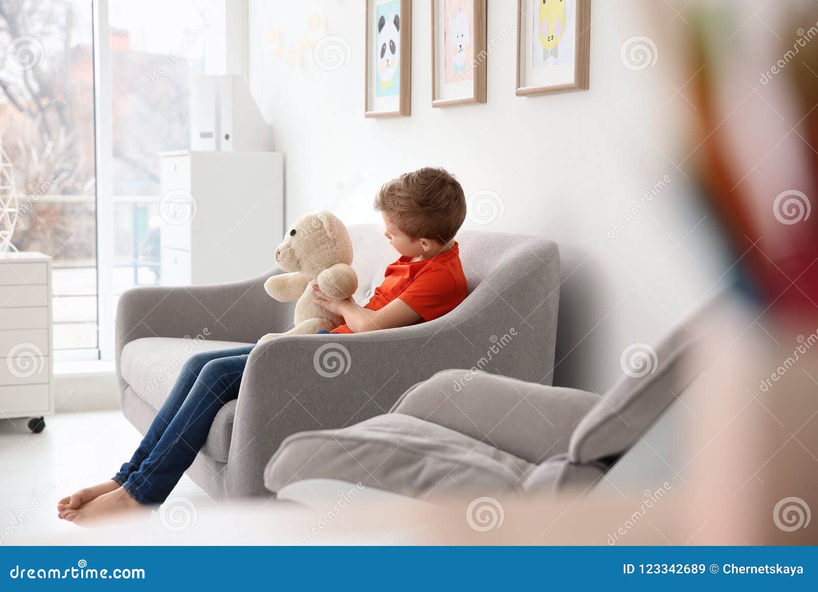 Little Autistic Boy Sitting on Sofa with Toy Stock Image - Image of ...