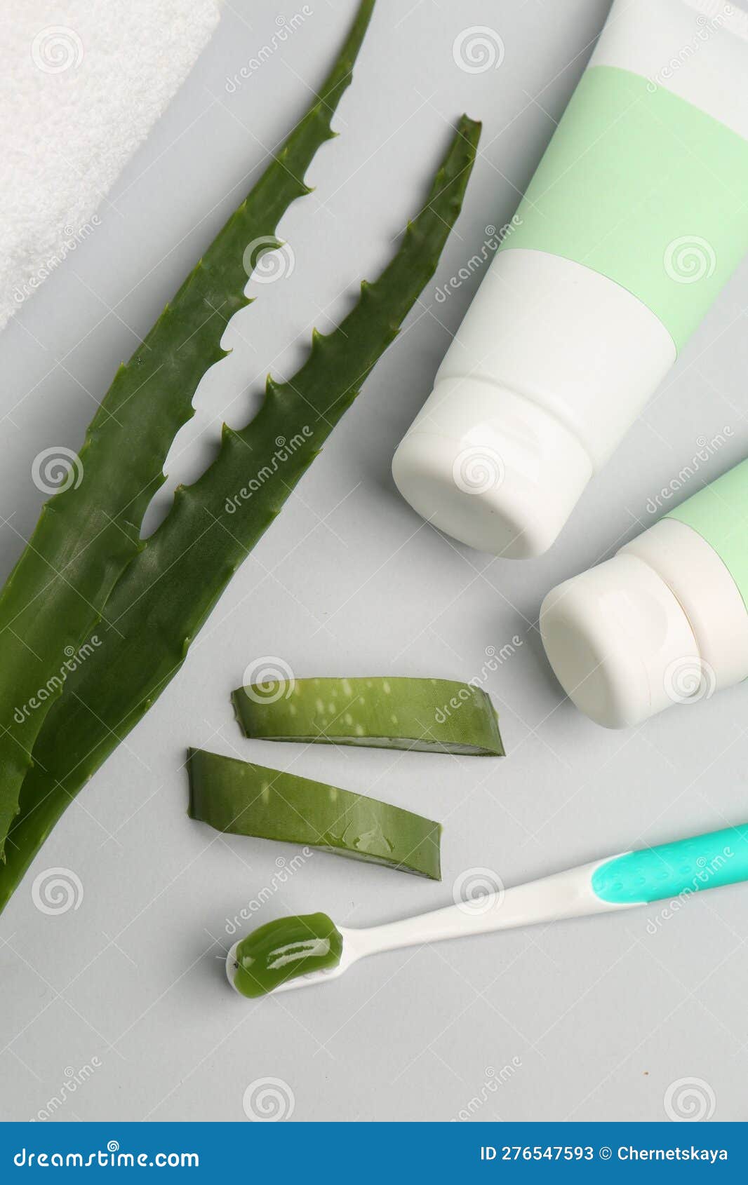 Tubes of Toothpaste, Toothbrush and Fresh Aloe on Light Grey Background ...