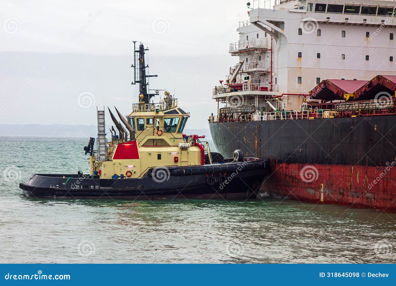 Tug Boat Assisting Huge Ship in Port Stock Photo - Image of work ...