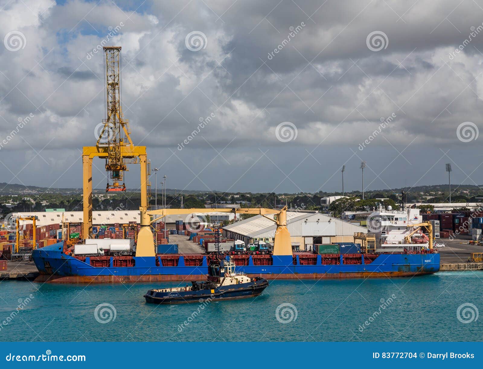 Tug at Freighter by Dock stock photo. Image of container - 83772704