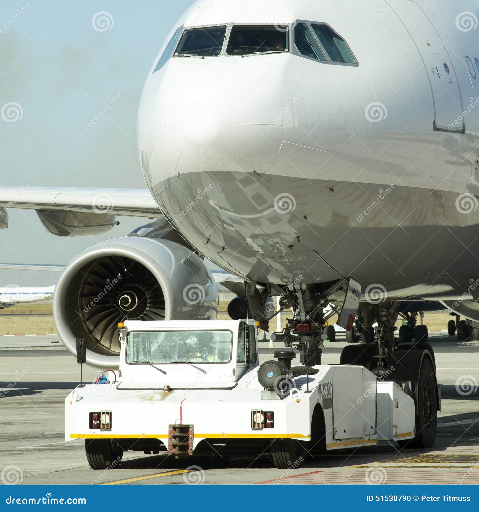 Tug moving a jet aircraft stock photo. Image of airport - 51530790