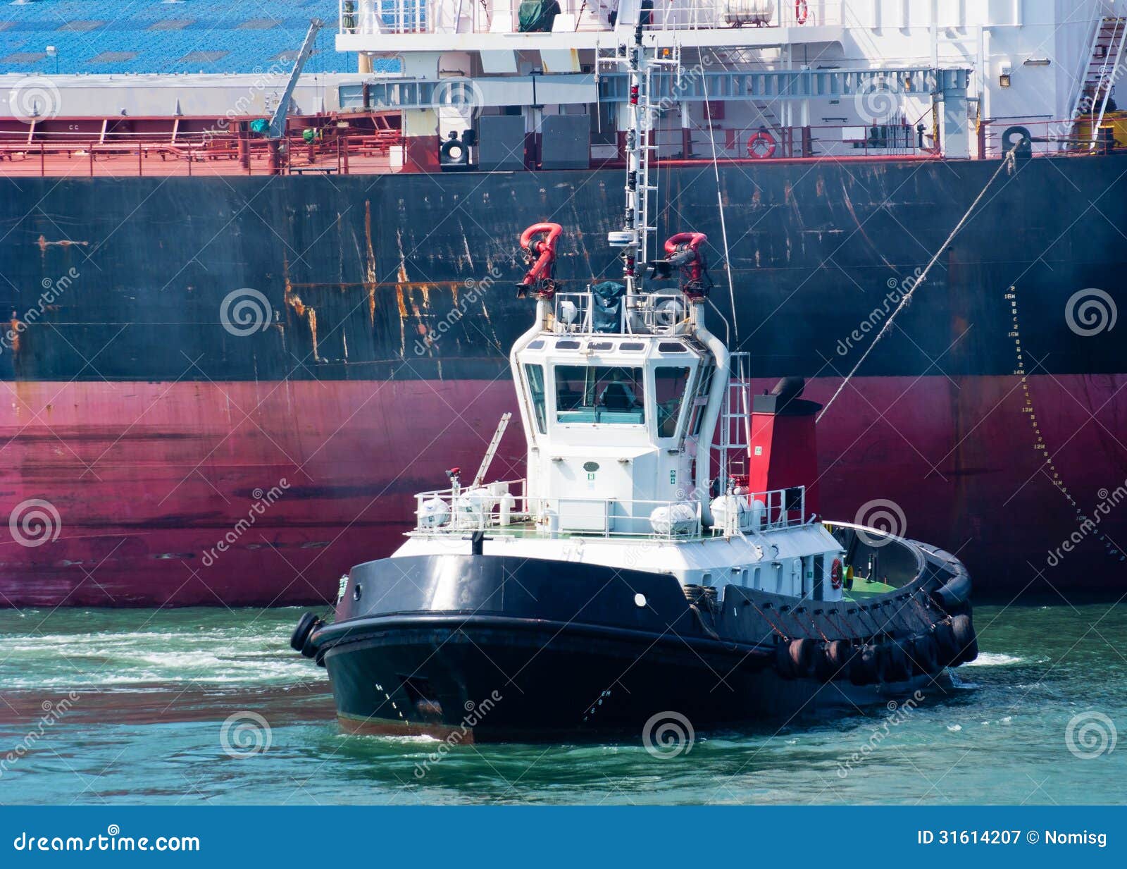 Tugboat pushing ship stock image. Image of white, water - 31614207
