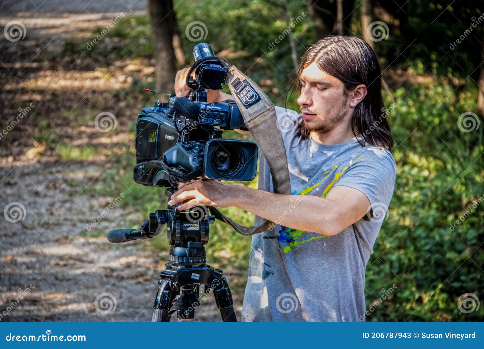 Casually Dressed Male Photojournalist Assembles Camera for Interview ...