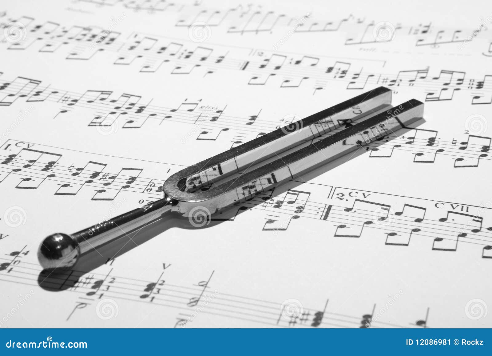 Tuning fork on sheet music stock image. Image of single - 12086981