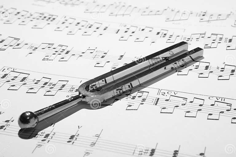Tuning fork on sheet music stock image. Image of single - 12086981