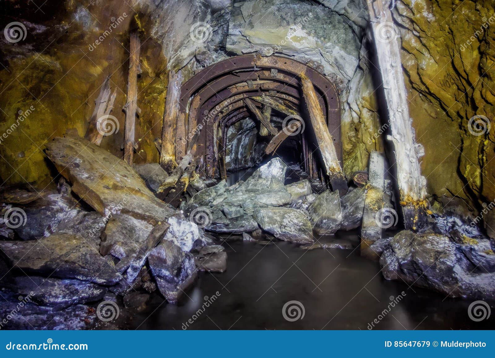 The Tunnel of an Old Abandoned Mine with Rusty Remnants of Trolleys ...