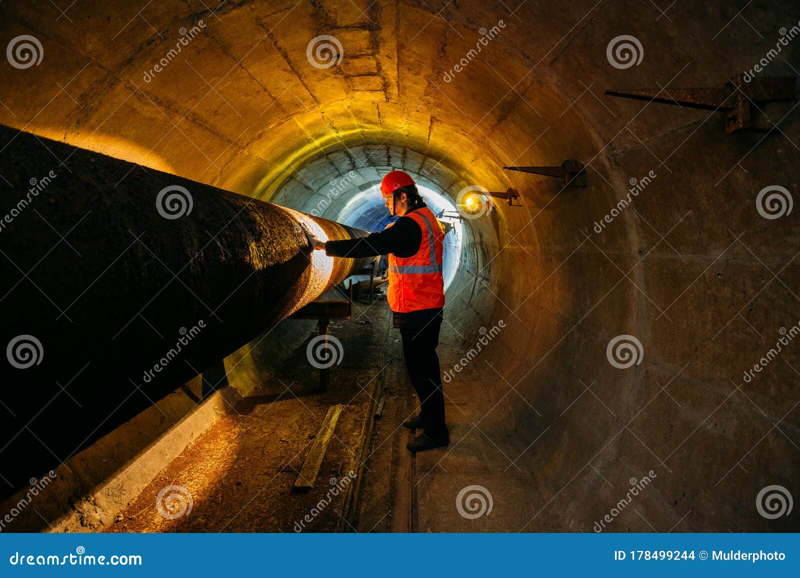 Tunnel Worker Examines Pipeline in Underground Tunnel Stock Photo ...