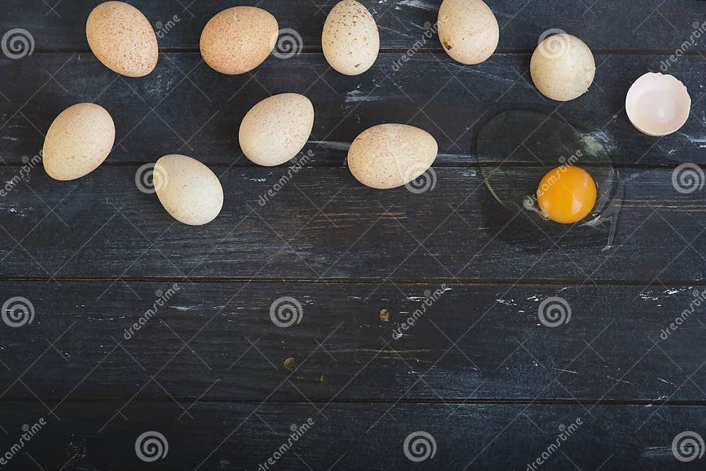 Turkey Eggs and One Broken Egg on Rough Dyed Wooden Surface. Stock ...