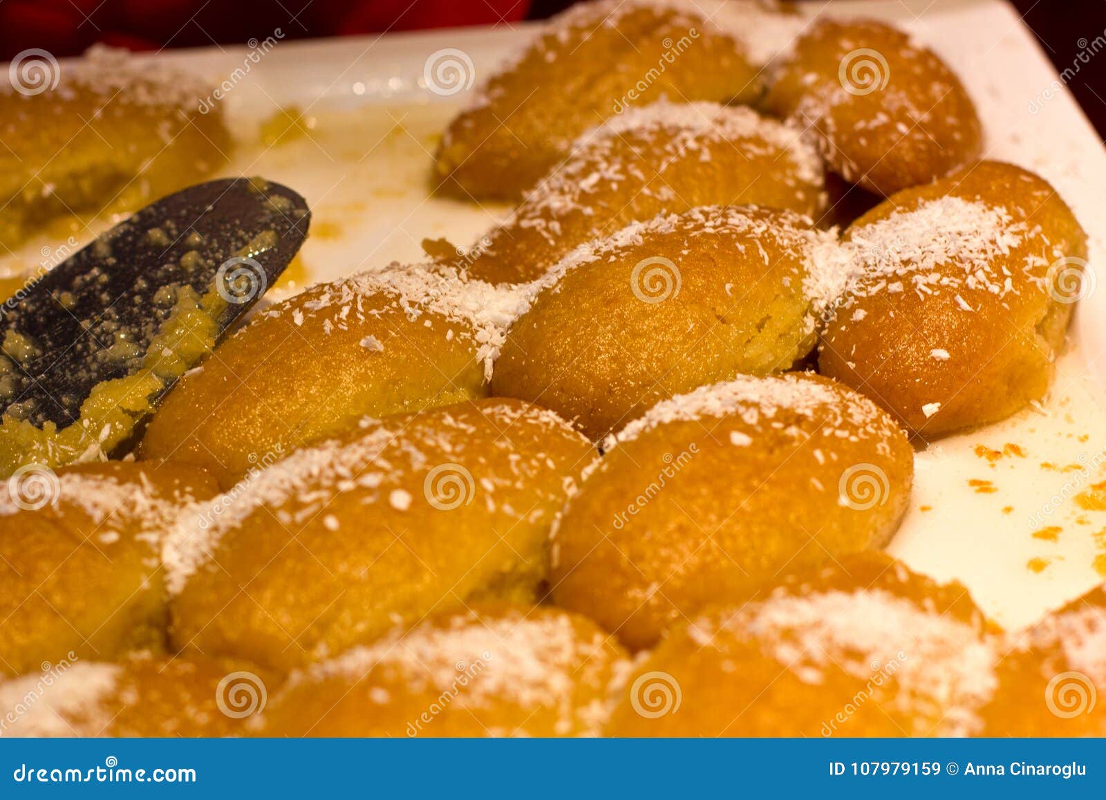 Turkish Sweets with Coconut Chips on a White Dish with a Silver Stock ...
