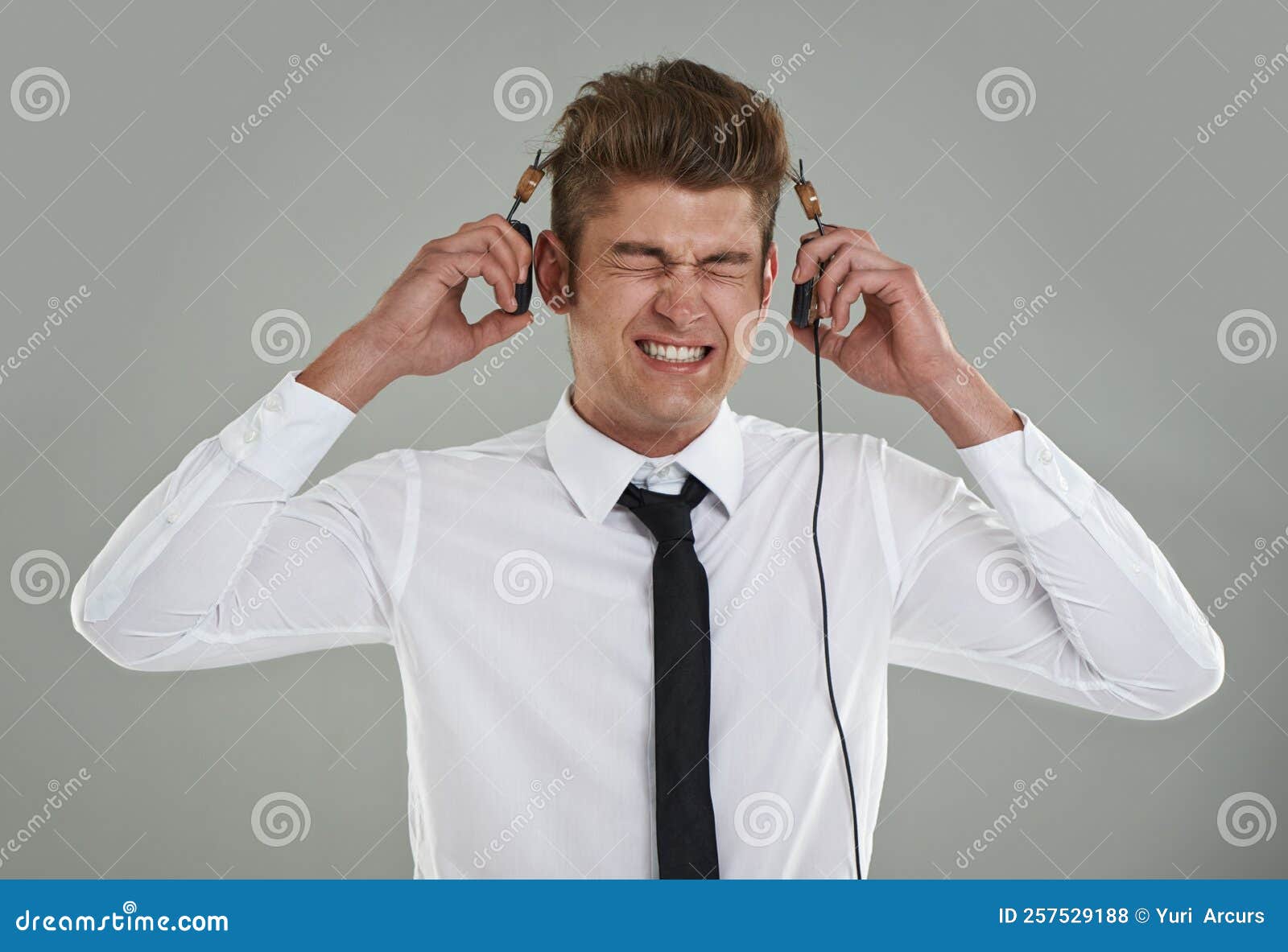 Turn it Down. a Young Man Pulling His Headphones Away from His Ears ...