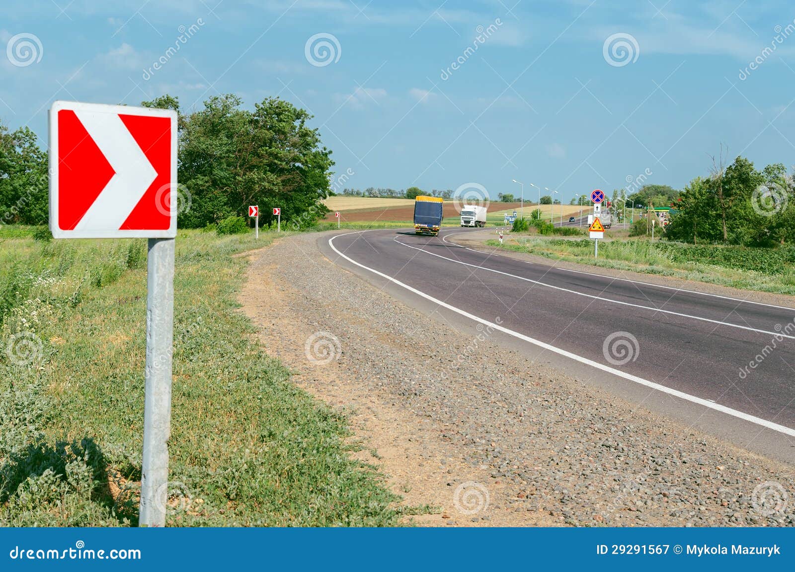 Sign Curved Road On The Way At The Natural Field Or Forest. Warning ...