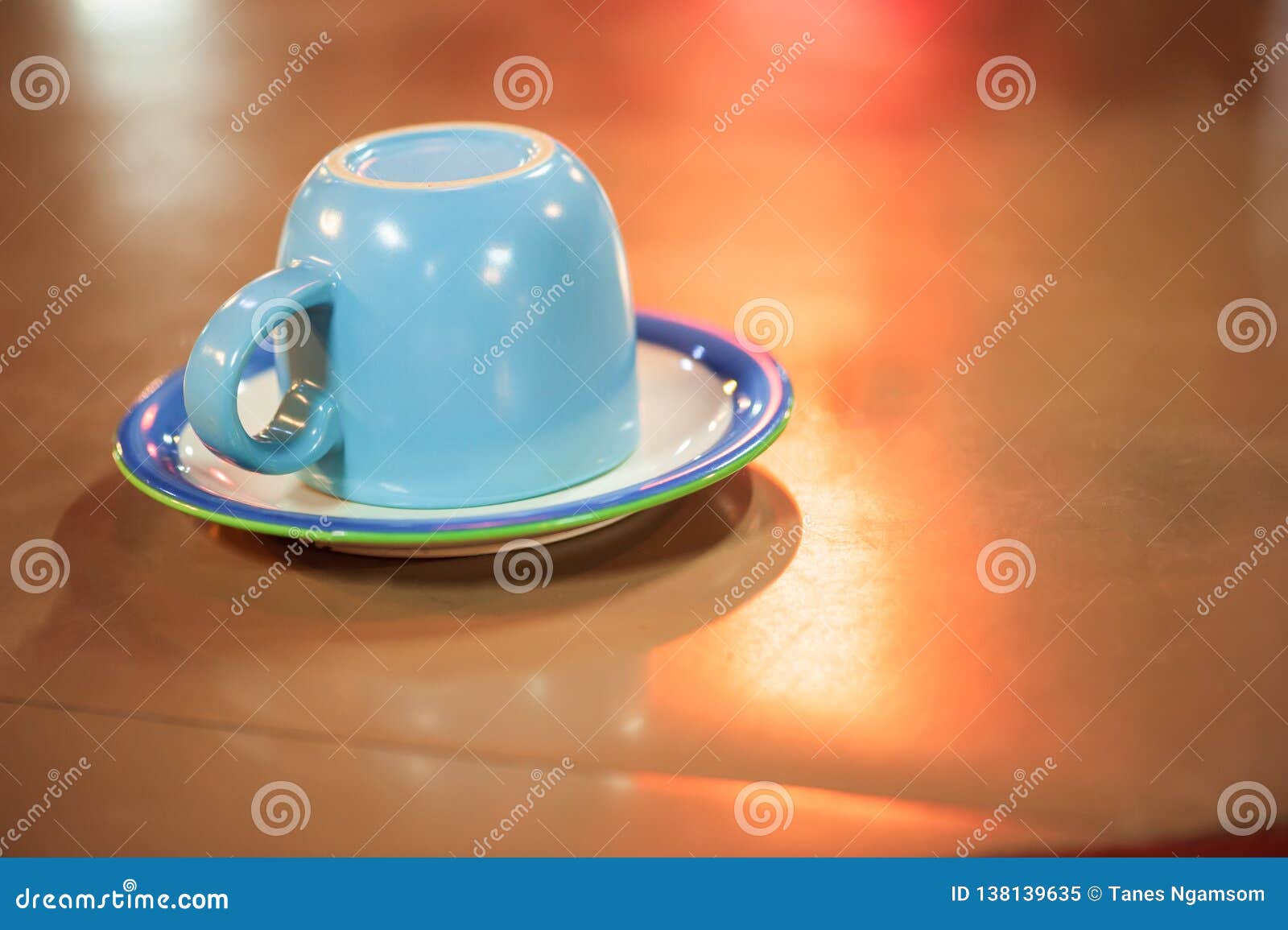 Turned Over Cup on a Table in Restaurant, Isolate on Colorful Light ...