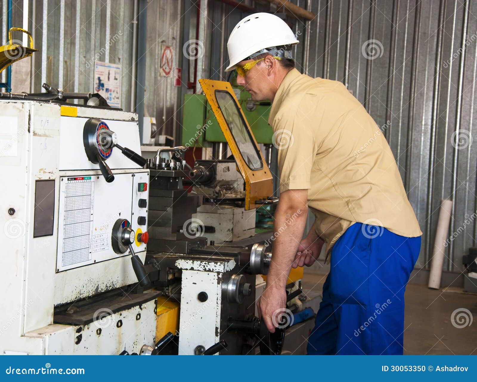 The Mechanic Works at the Lathe at Factory Stock Photo - Image of ...