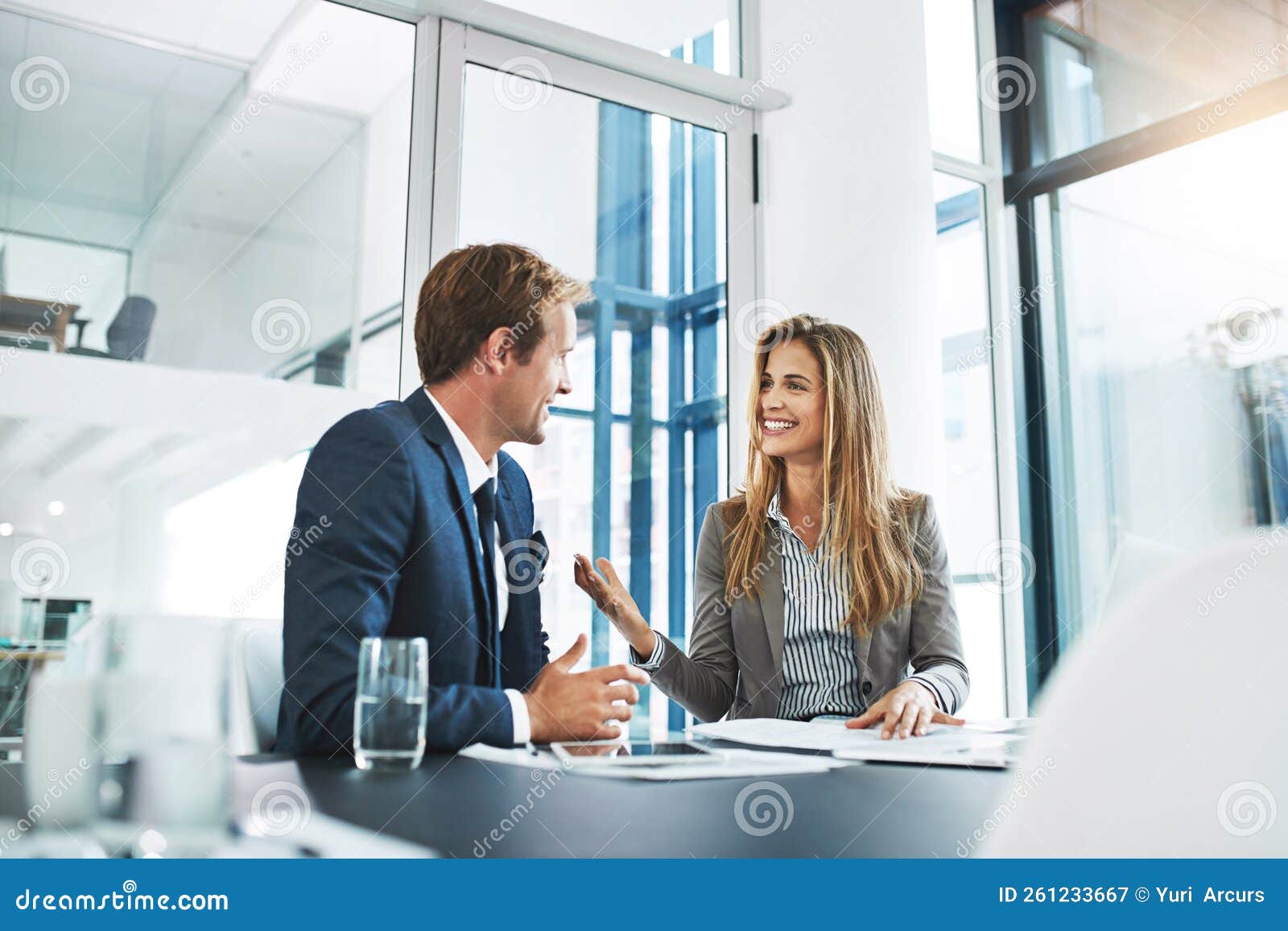 Turning Knowledge into Action. Two Businesspeople Having a Discussion ...