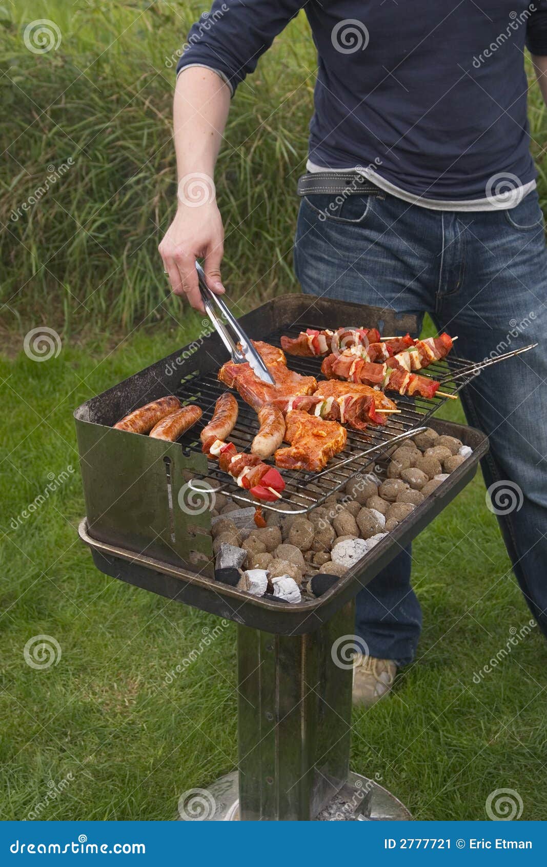 Turning meat on barbecue stock image. Image of person - 2777721