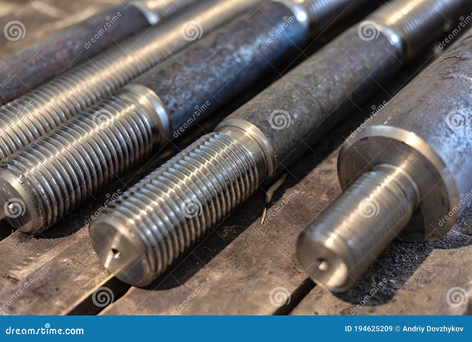 After Turning and Milling, the Threaded Studs Lie on a Wooden Rack in ...