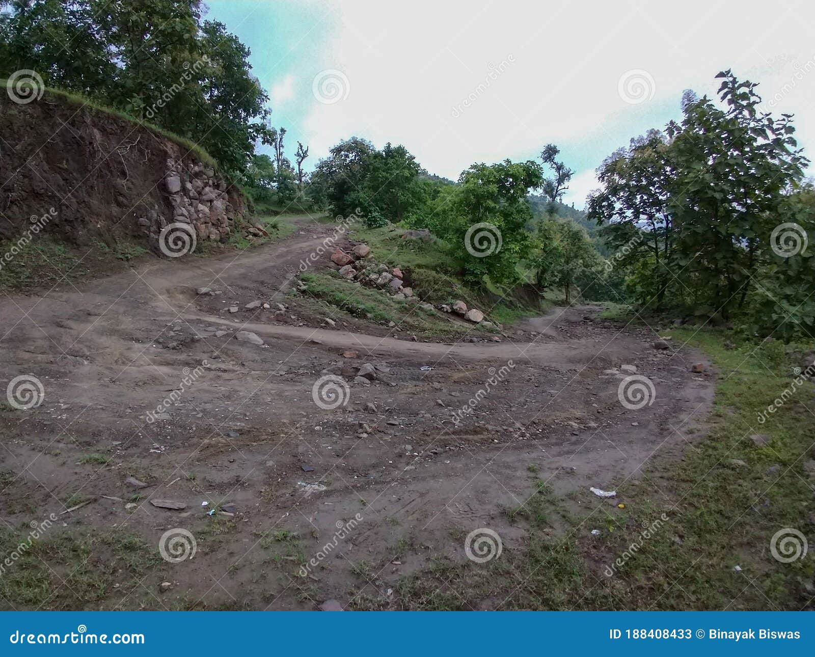 Turning Point of a Rocky Hilly Mud Road in a Forest at Evening Time ...