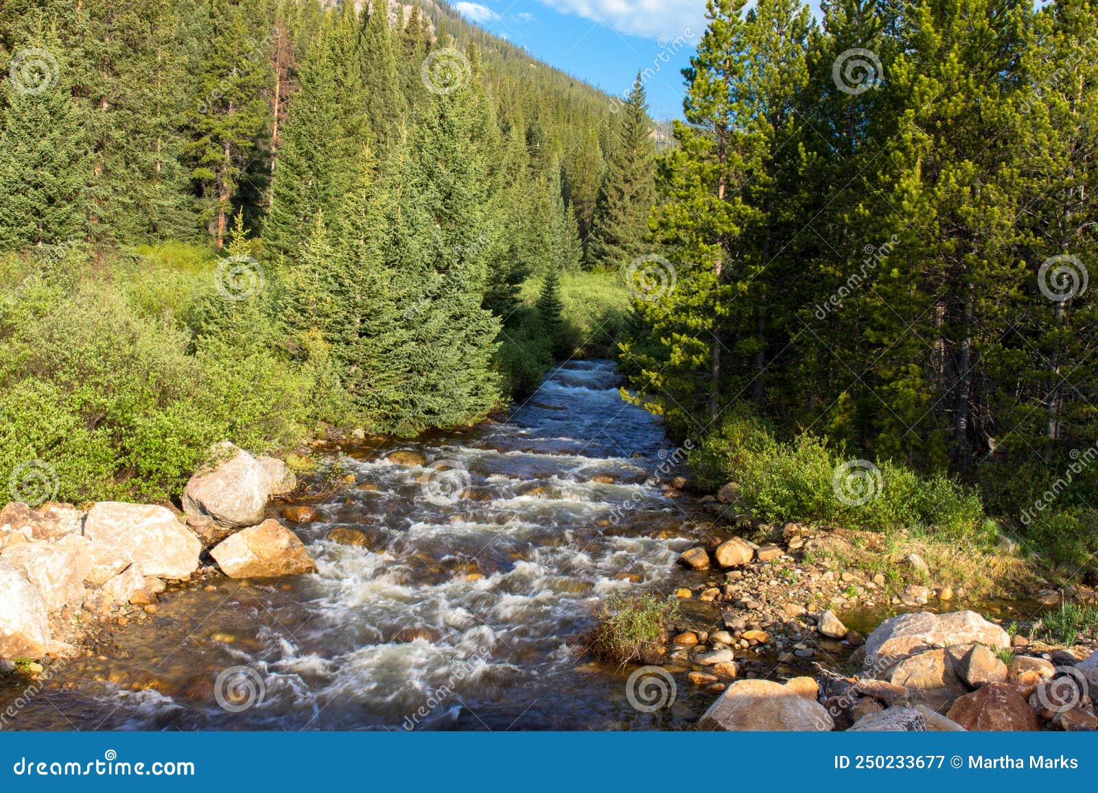 A Stream Flows Over Rocks Toward Turquoise Lake Stock Image - Image of ...
