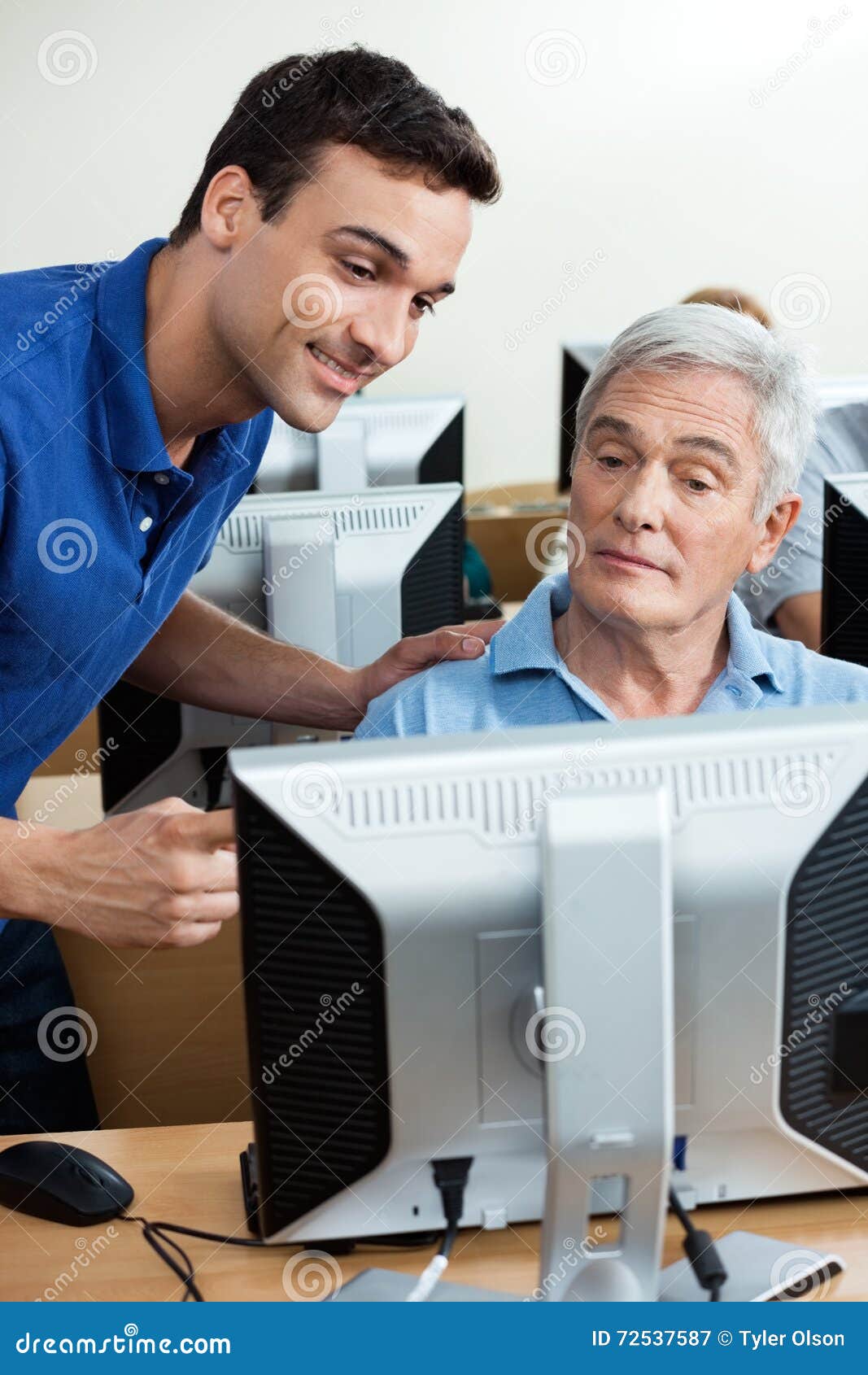 Tutor Assisting Senior Man in Using Computer at Classroom Stock Image ...