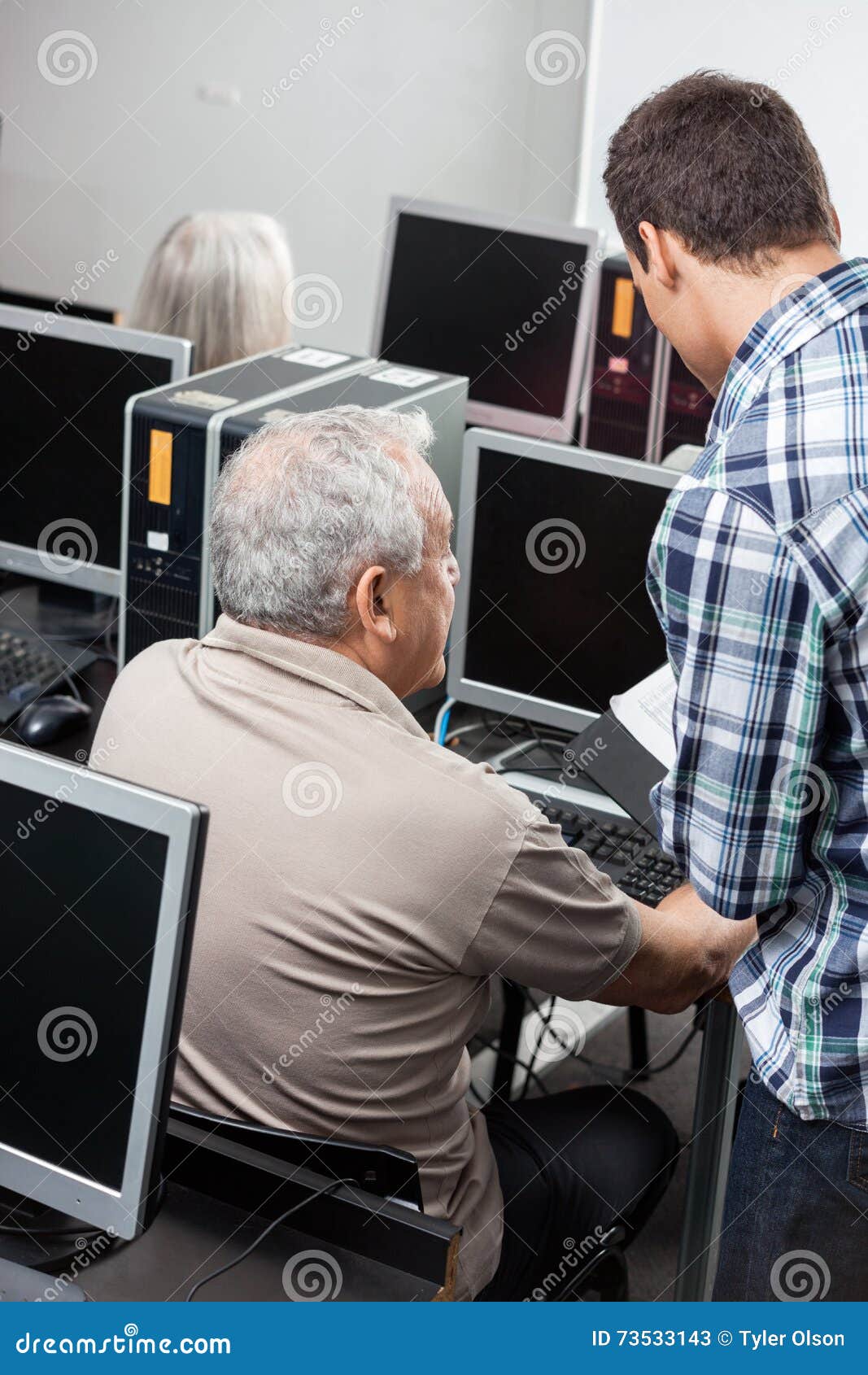 Tutor Assisting Senior Man in Using Computer at Classroom Stock Image ...