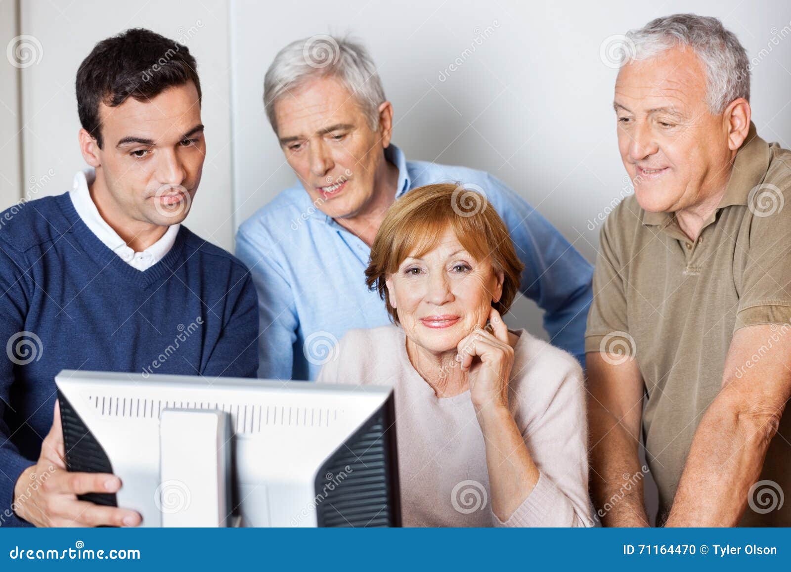 Tutor Assisting Senior People in Using Computer at Class Stock Photo ...