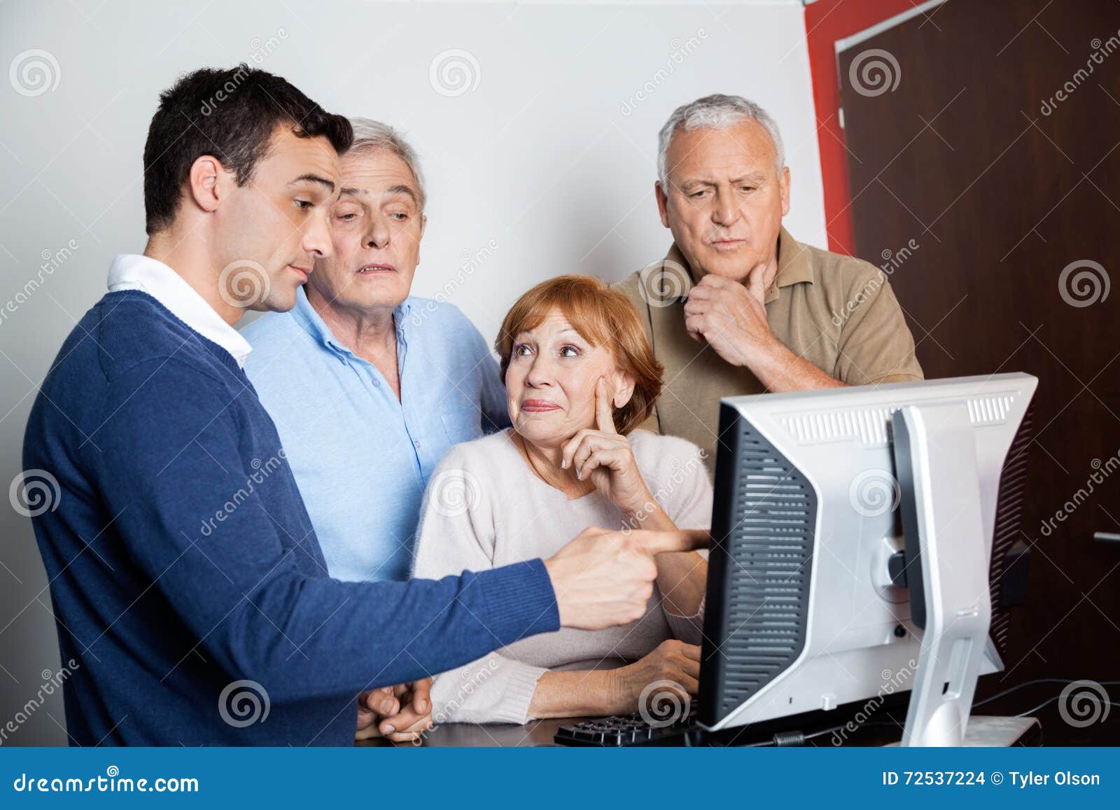 Tutor Assisting Senior People in Using Computer at Classroom Stock ...