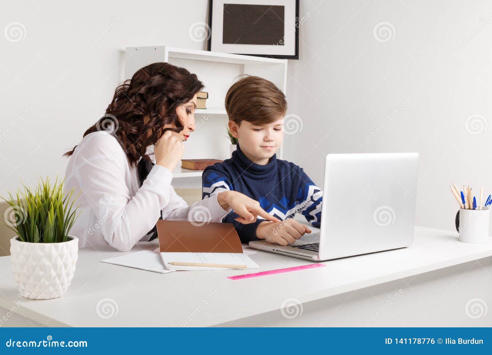 Tutor and the Boy Doing Homework in the White Classroom. Typing ...