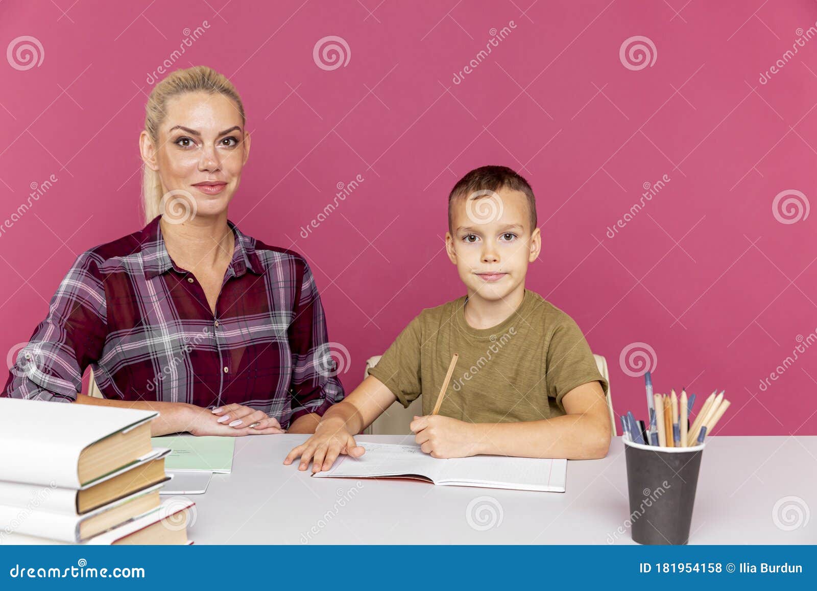 Tutor with Child Doing Homework Together in the Pink Room. Stock Photo ...