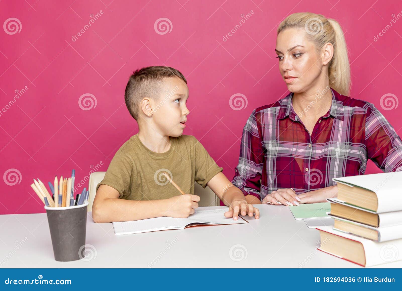 Tutor with Child Doing Homework Together in the Pink Room. Stock Photo ...