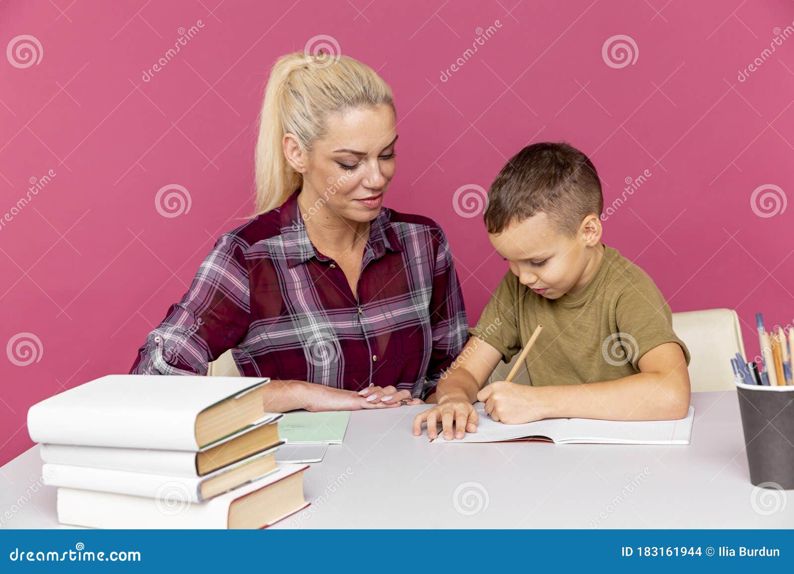 Tutor with Child Doing Homework Together in the Pink Room. Stock Photo ...