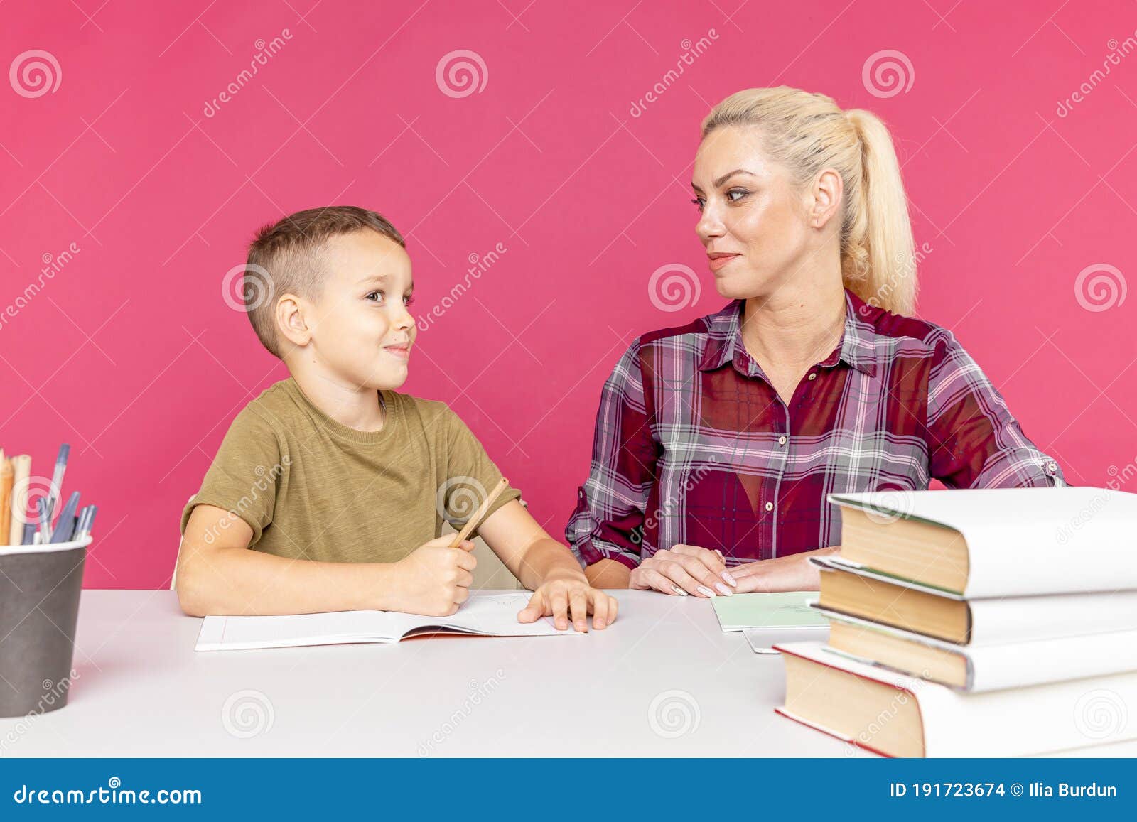 Tutor with Child Doing Homework Together in the Pink Room. Stock Photo ...