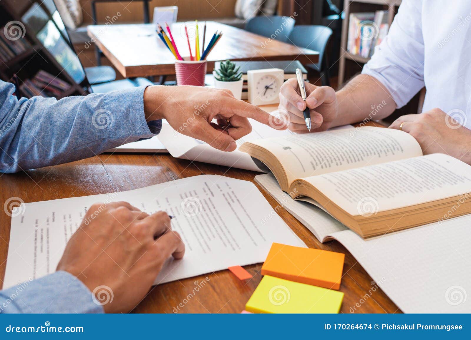 Tutor and College Students Teaching School Work and Explaining Problem ...